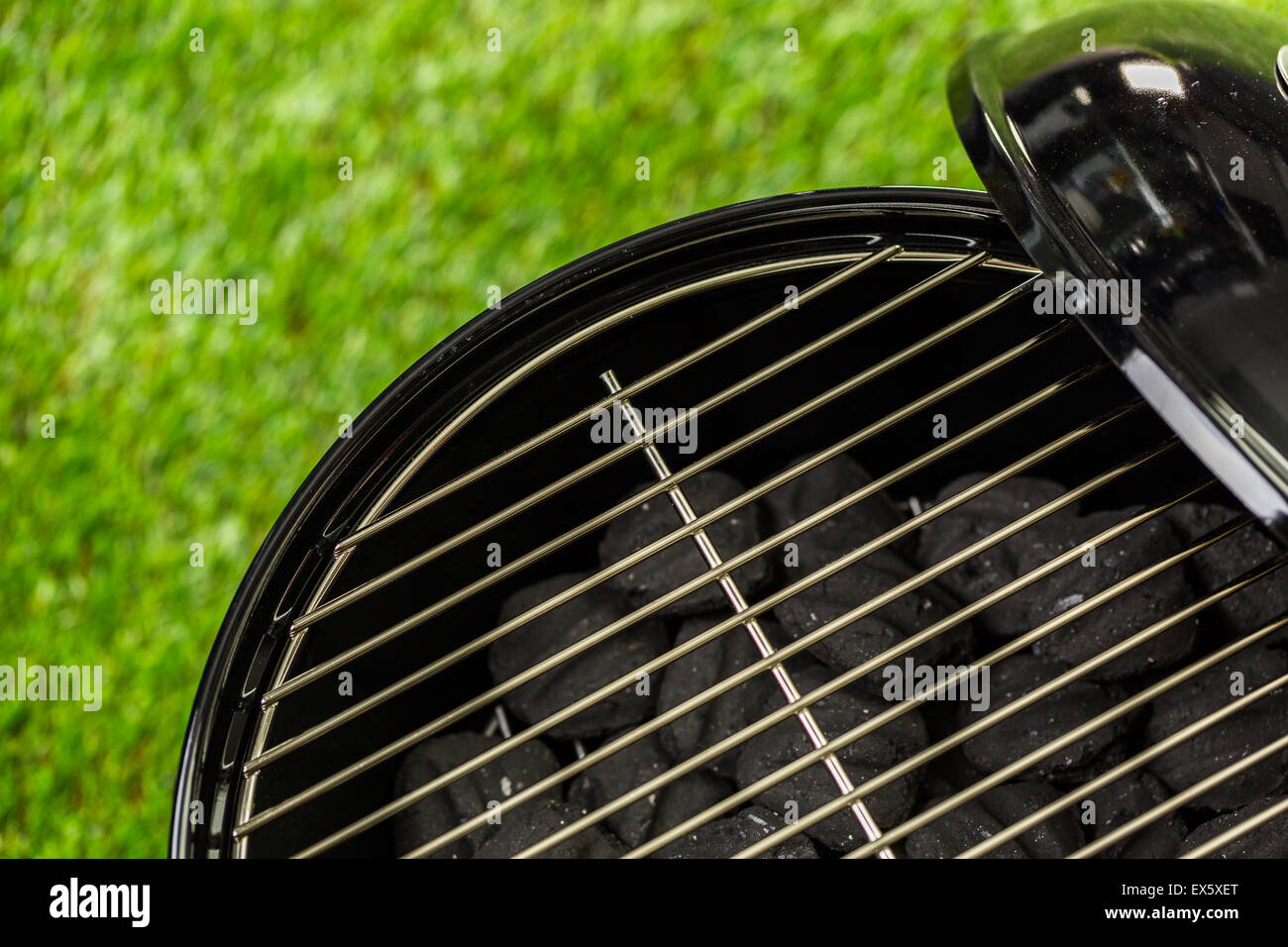 Small round charcoal grill ready for grilling at the summer picnic ...
