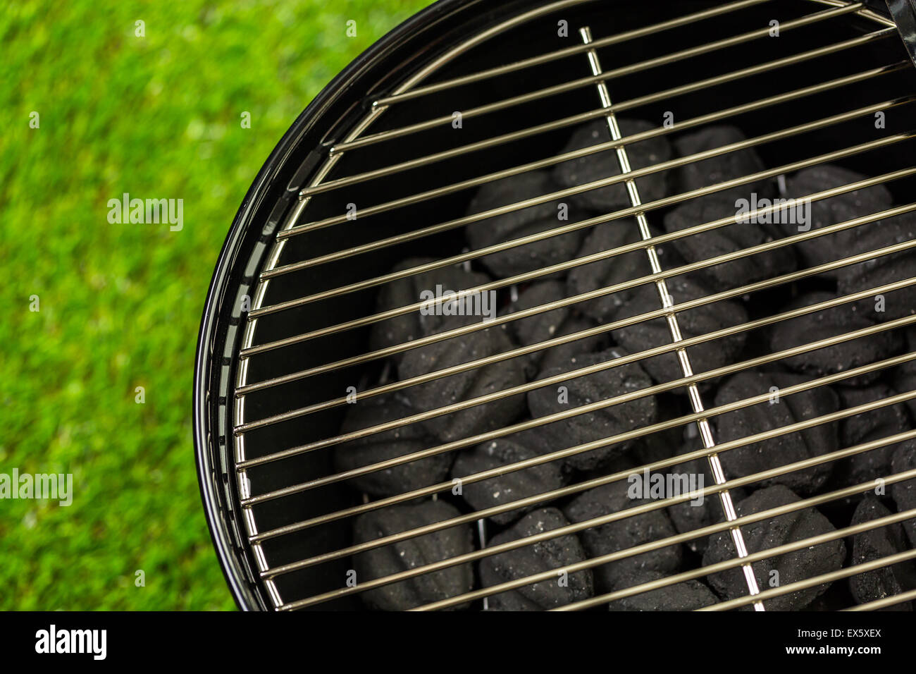 Small round charcoal grill ready for grilling at the summer picnic ...