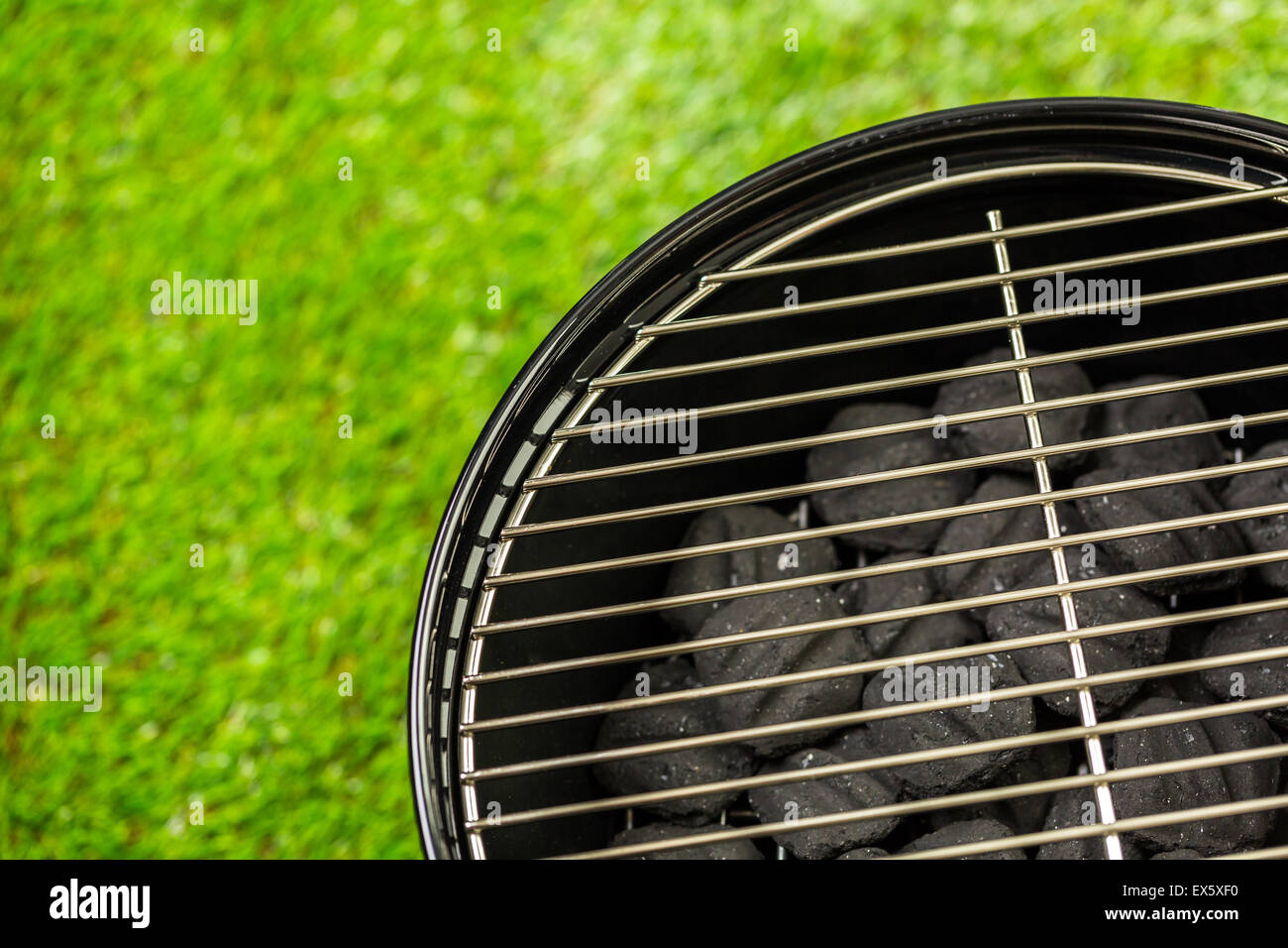 Small round charcoal grill ready for grilling at the summer picnic ...