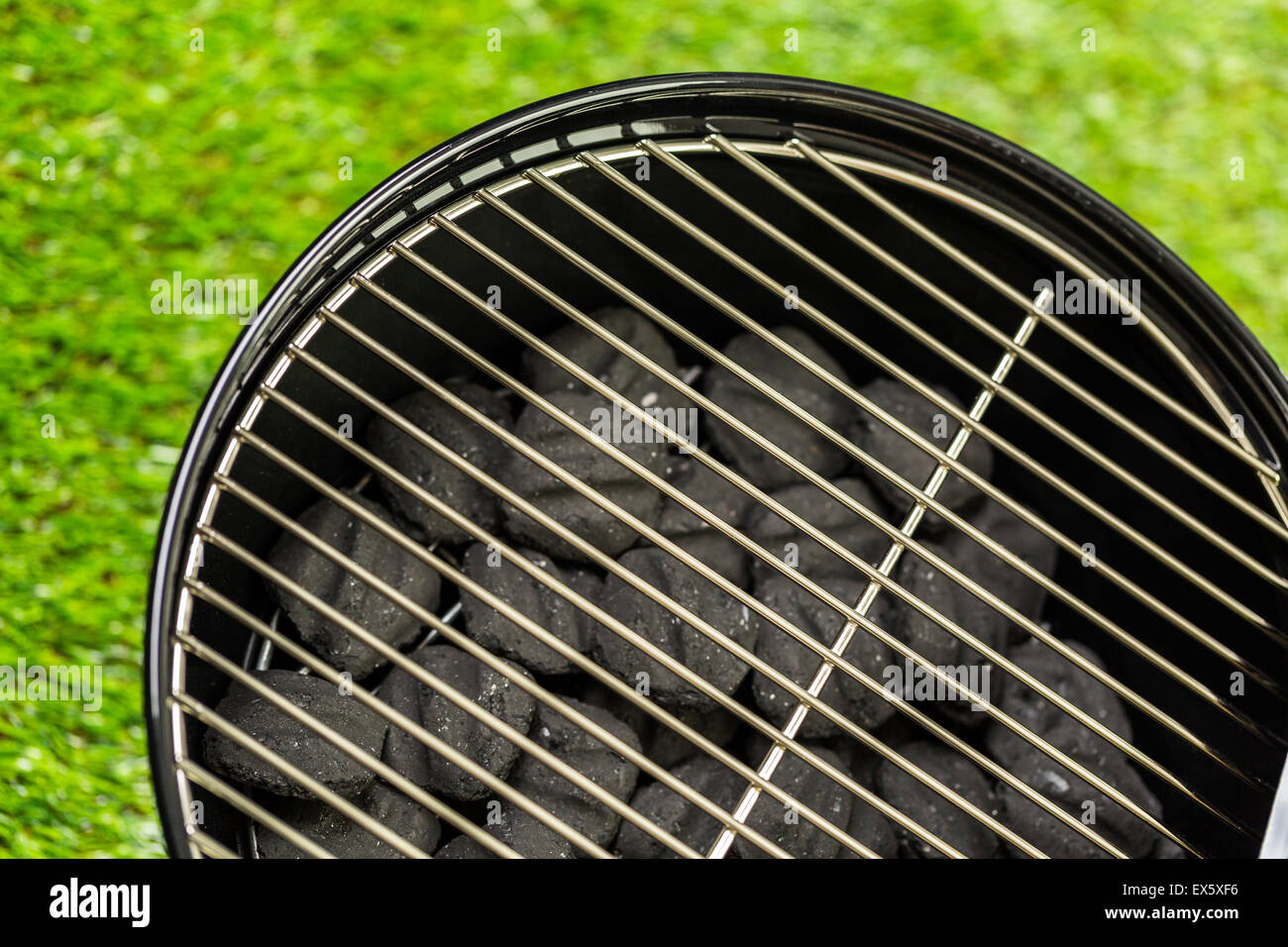Small round charcoal grill ready for grilling at the summer picnic ...