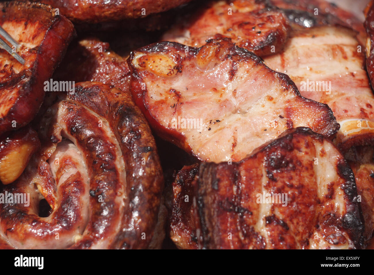 Barbecuing meat on charcoal fire closeup image Stock Photo - Alamy