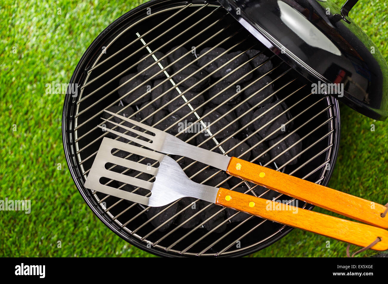 Small round charcoal grill ready for grilling at the summer picnic ...
