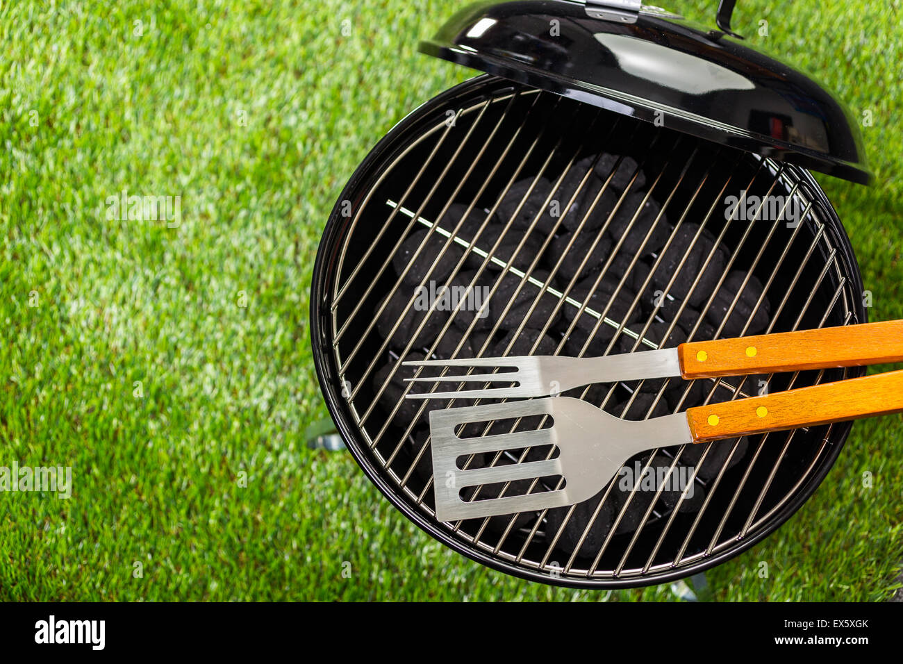 Small round charcoal grill ready for grilling at the summer picnic ...