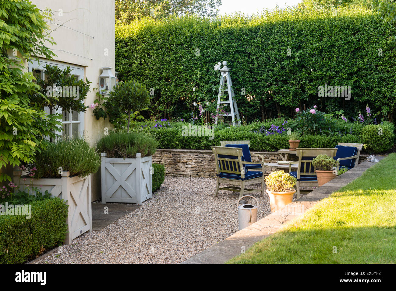 Box hedge and wooden furniture in english country garden Stock Photo ...