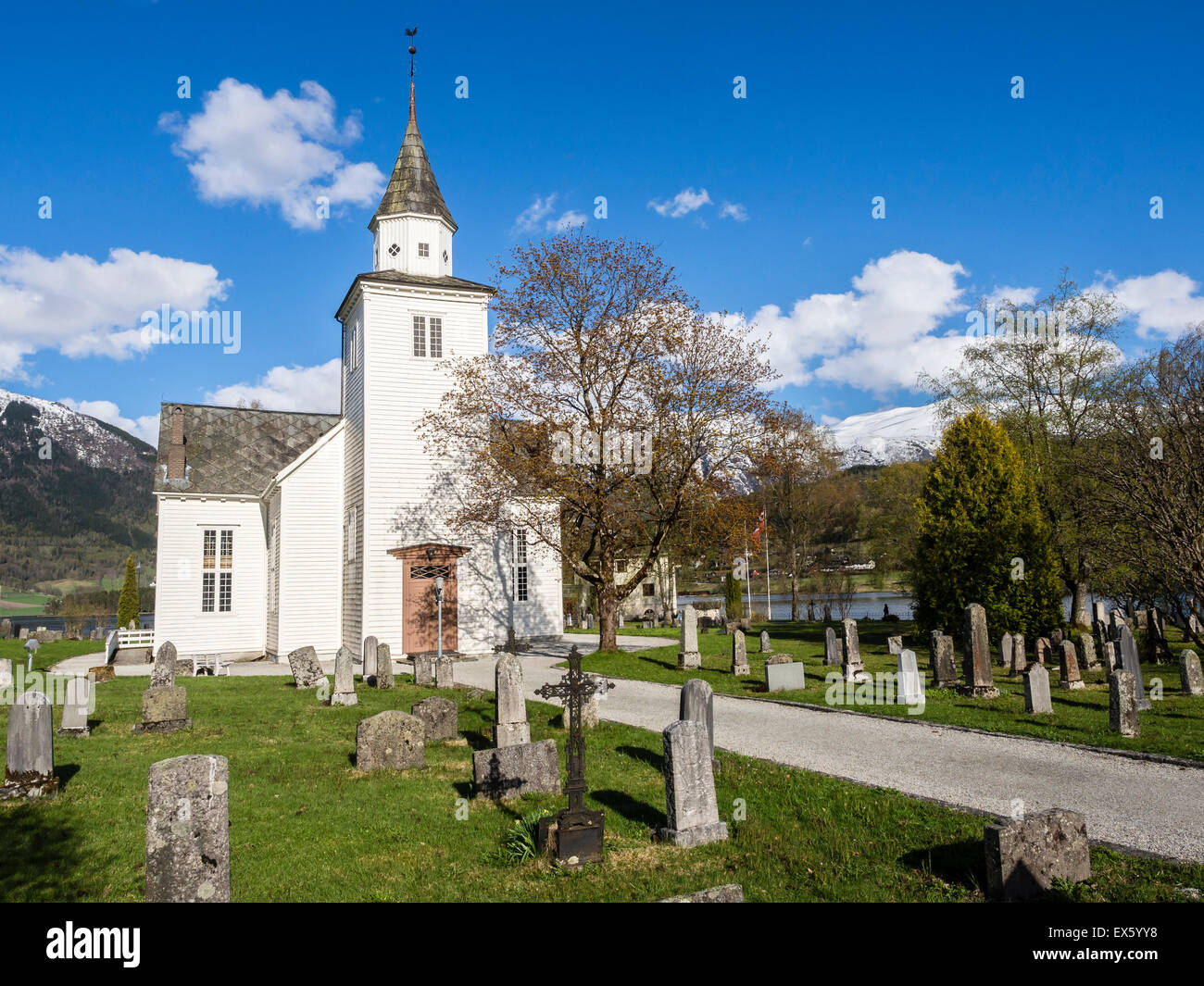 Church of Ulvik, spring, snow covered mountains in the background ...