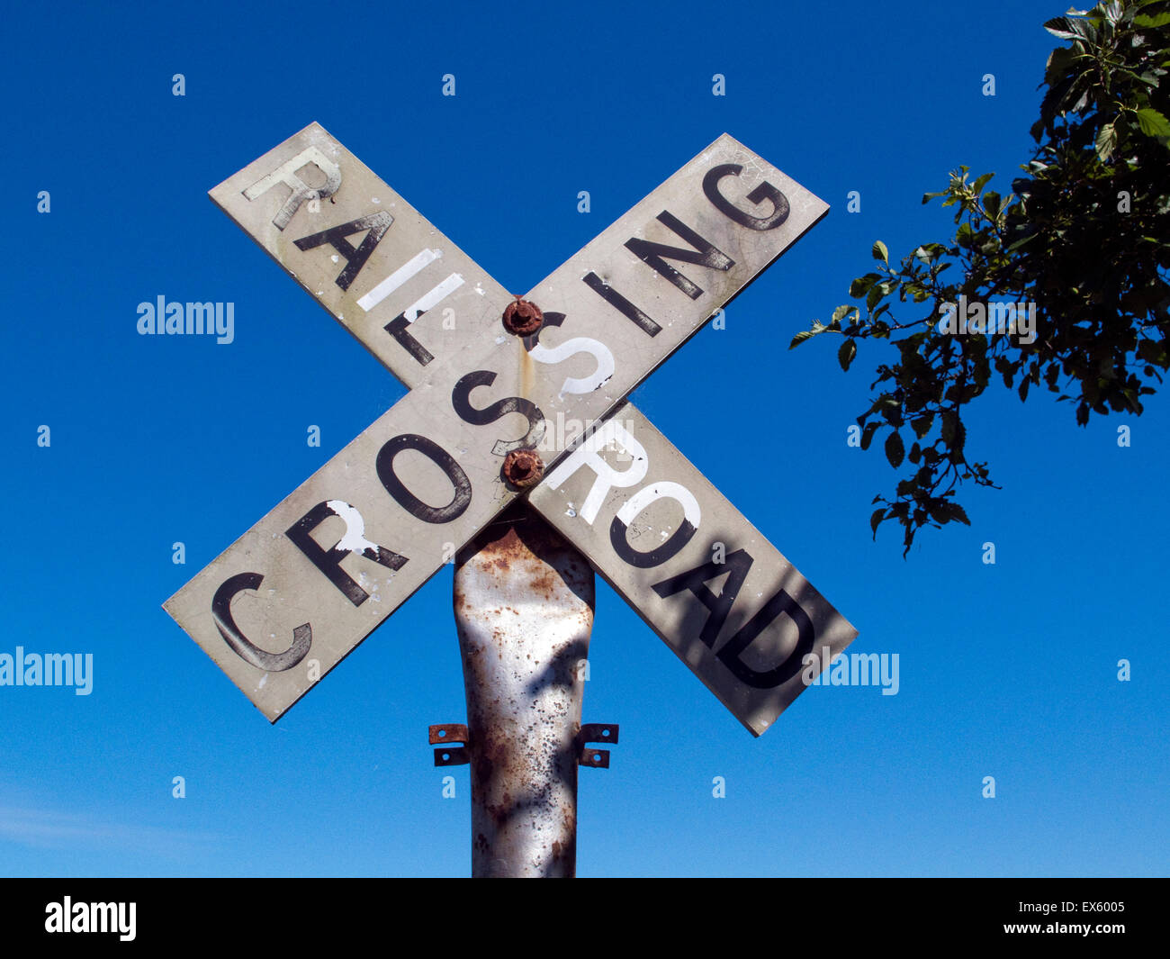 Astoria, Oregon, USA. Rustic faded metal Railroad Crossing sign against ...