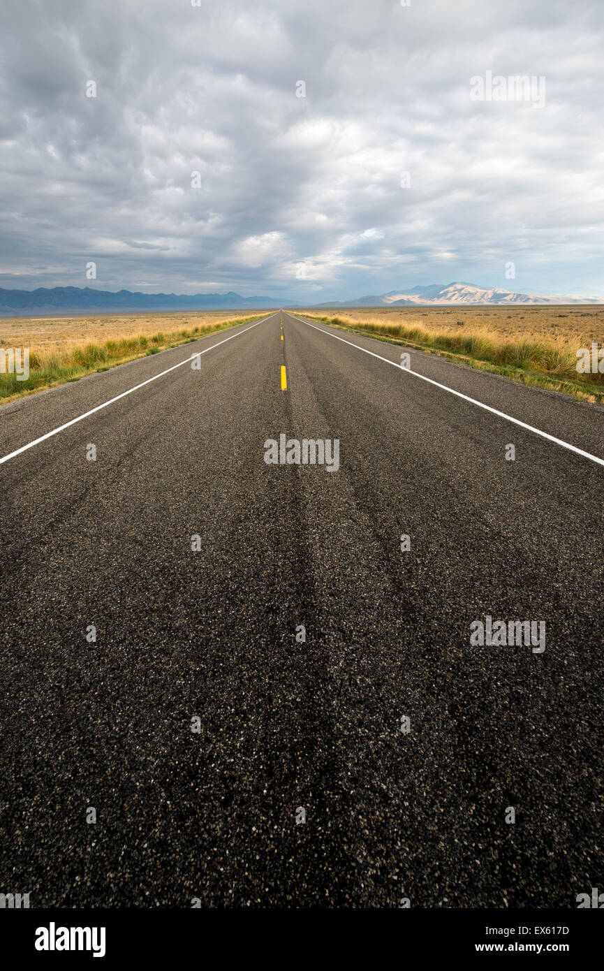 Empty open road with cloudy sky photographed from a low angle with a ...