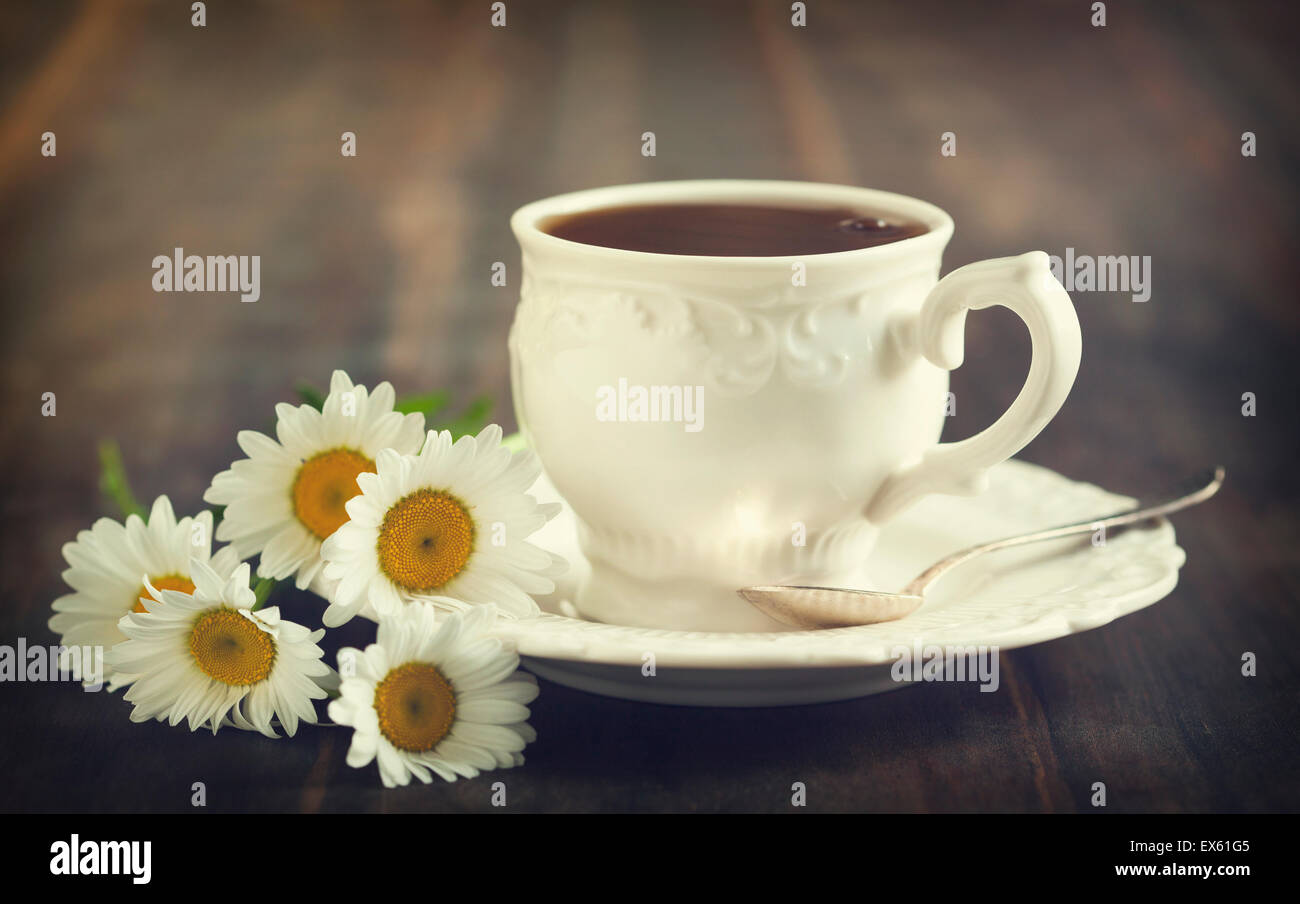 Cup of tea and chamomiles Stock Photo - Alamy