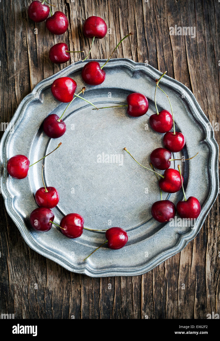 Sweet cherry on metal vintage plate Stock Photo - Alamy