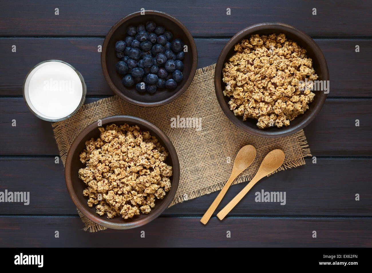 Dried berry and oatmeal breakfast cereal in rustic bowls with fresh ...