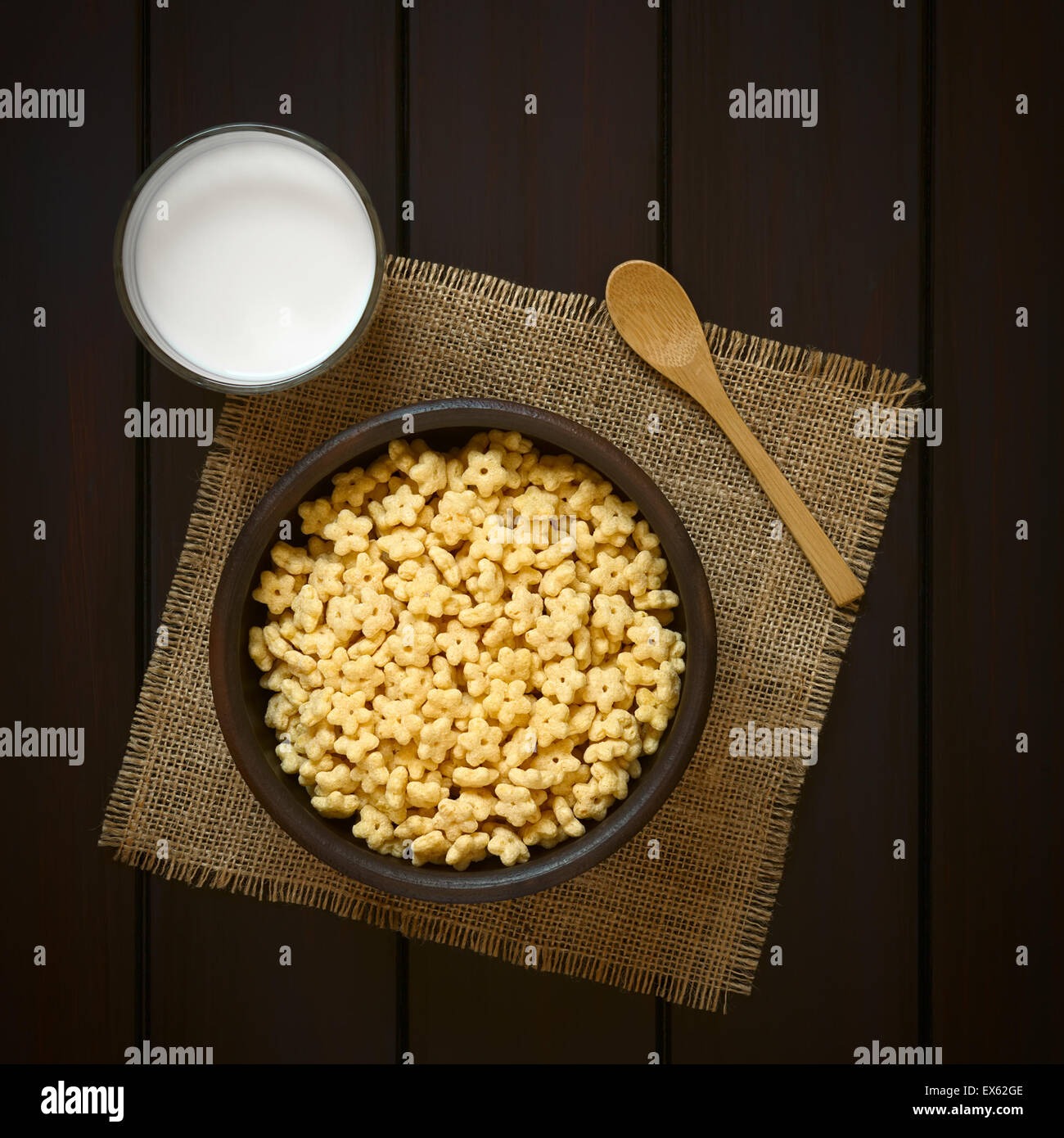 Honey flavored breakfast cereal in rustic bowl with a glass of milk and ...