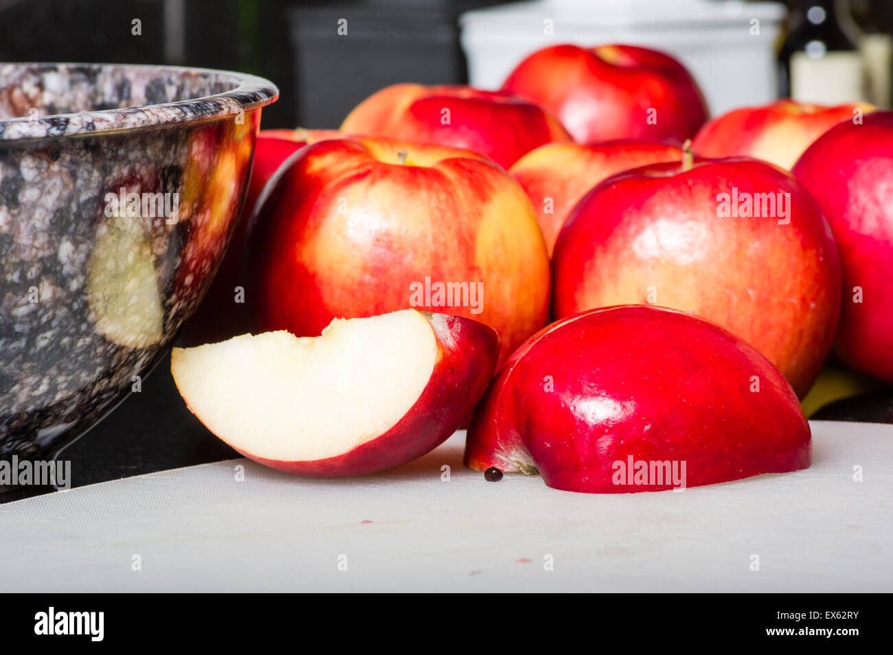 Red apples on cutting board sliced ready to cook Stock Photo - Alamy