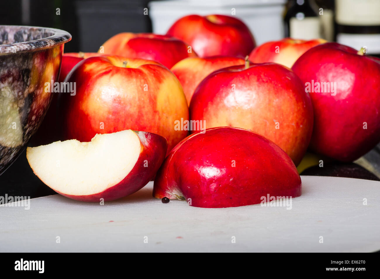 Red apples on cutting board sliced ready to cook Stock Photo - Alamy