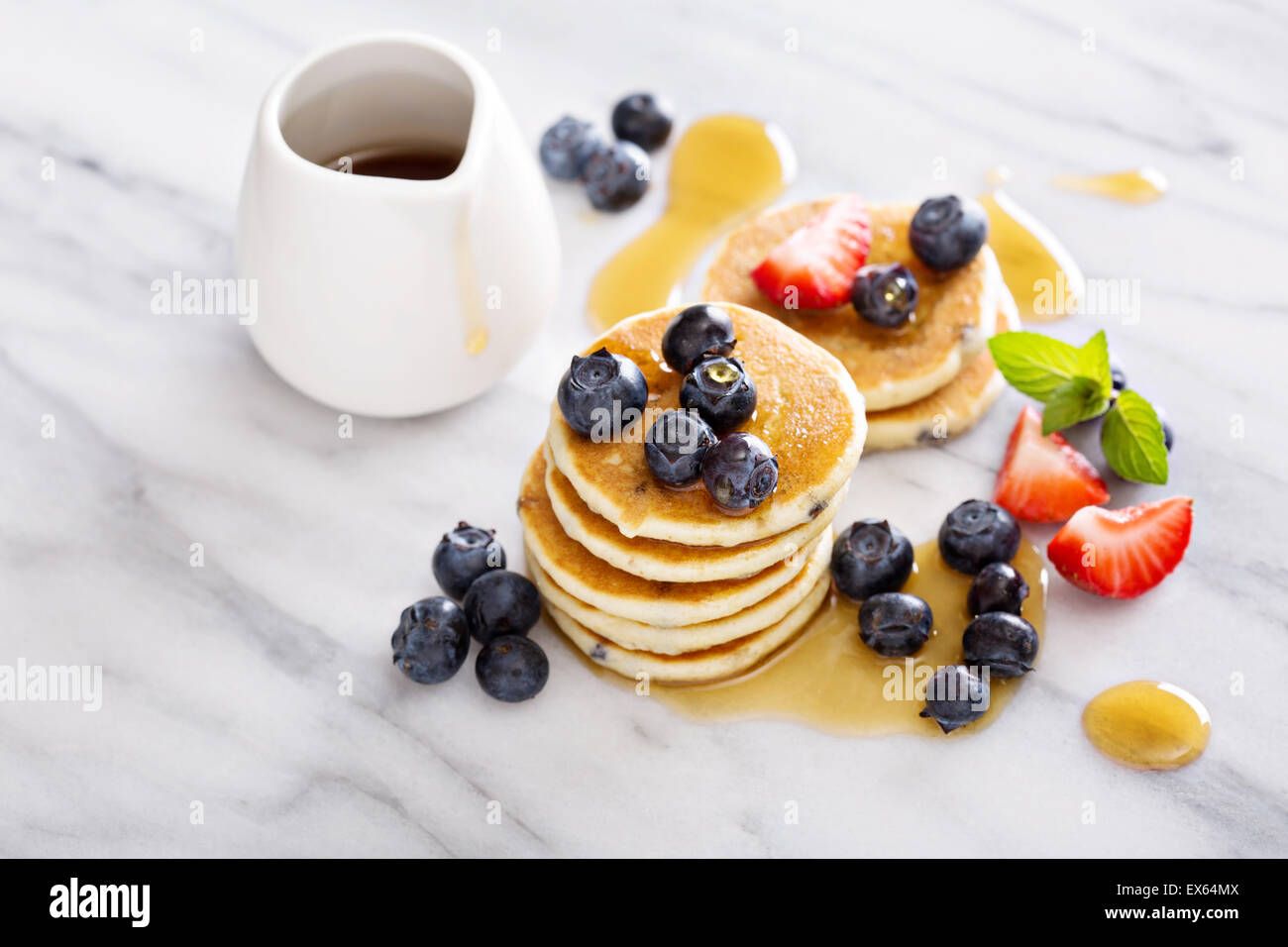 Stack of small pancakes with berries on marble board Stock Photo - Alamy