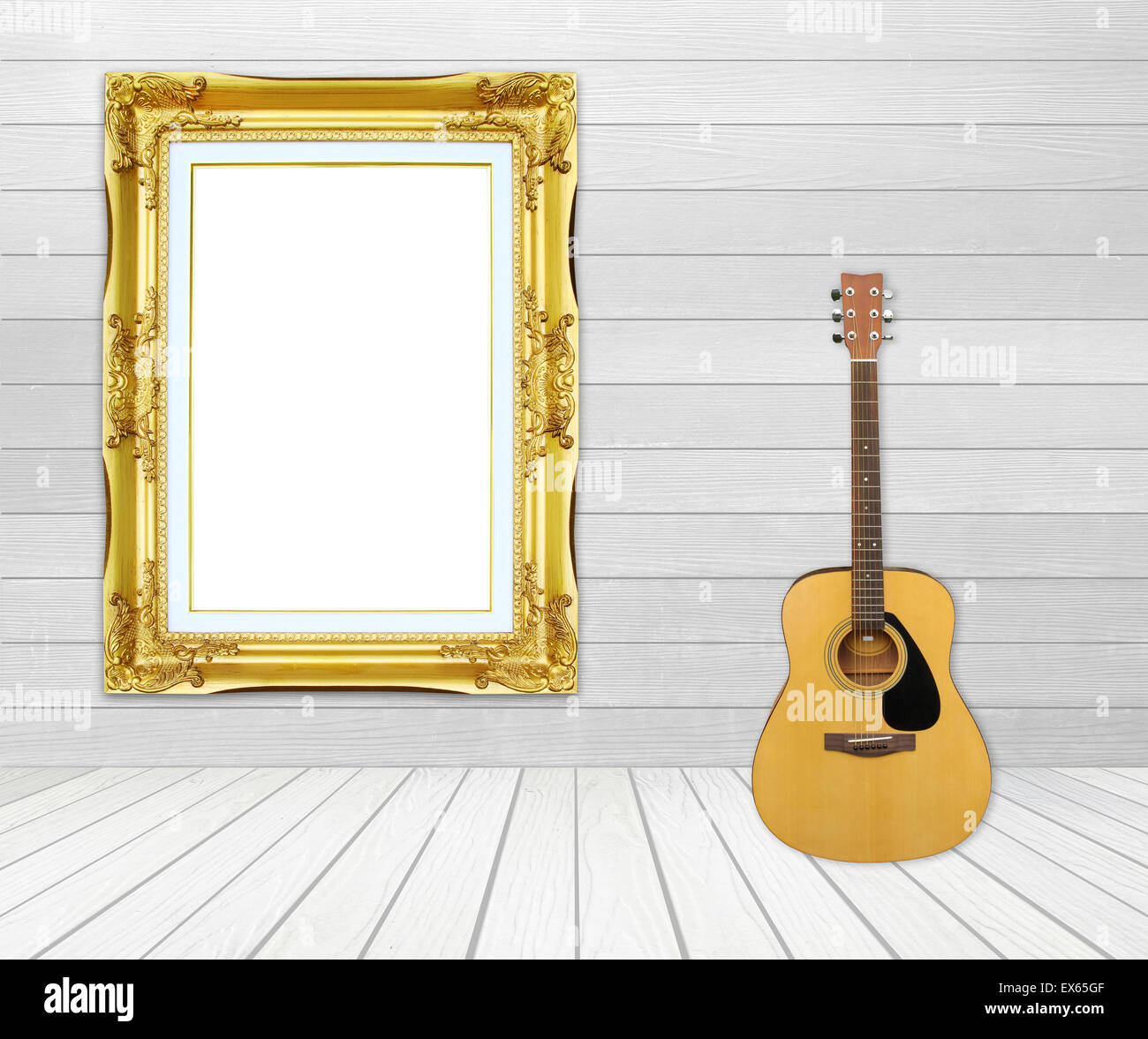 Guitar and picture frame in white room Stock Photo - Alamy
