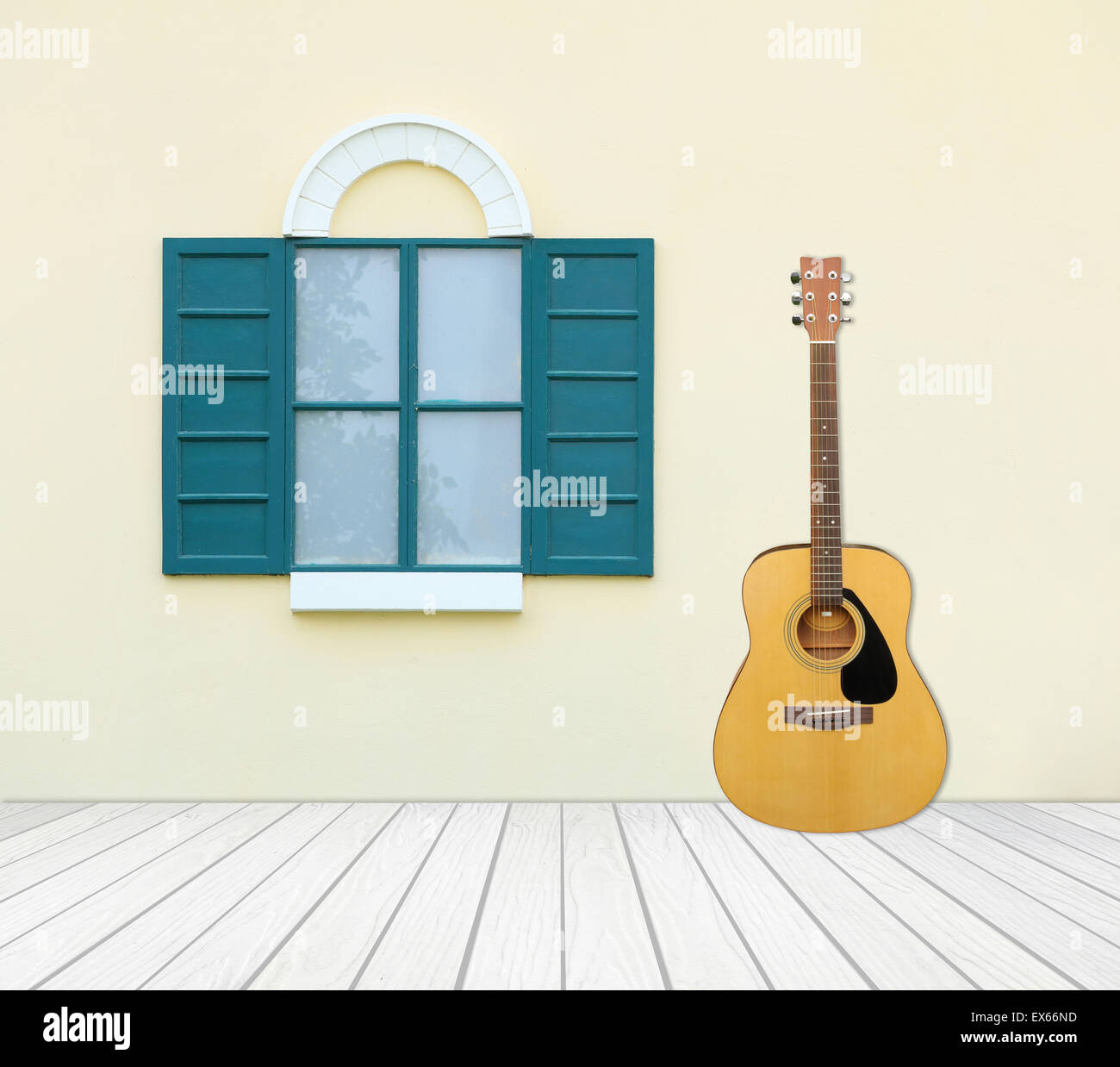 Guitar with window on cement wall and wood floor Stock Photo - Alamy