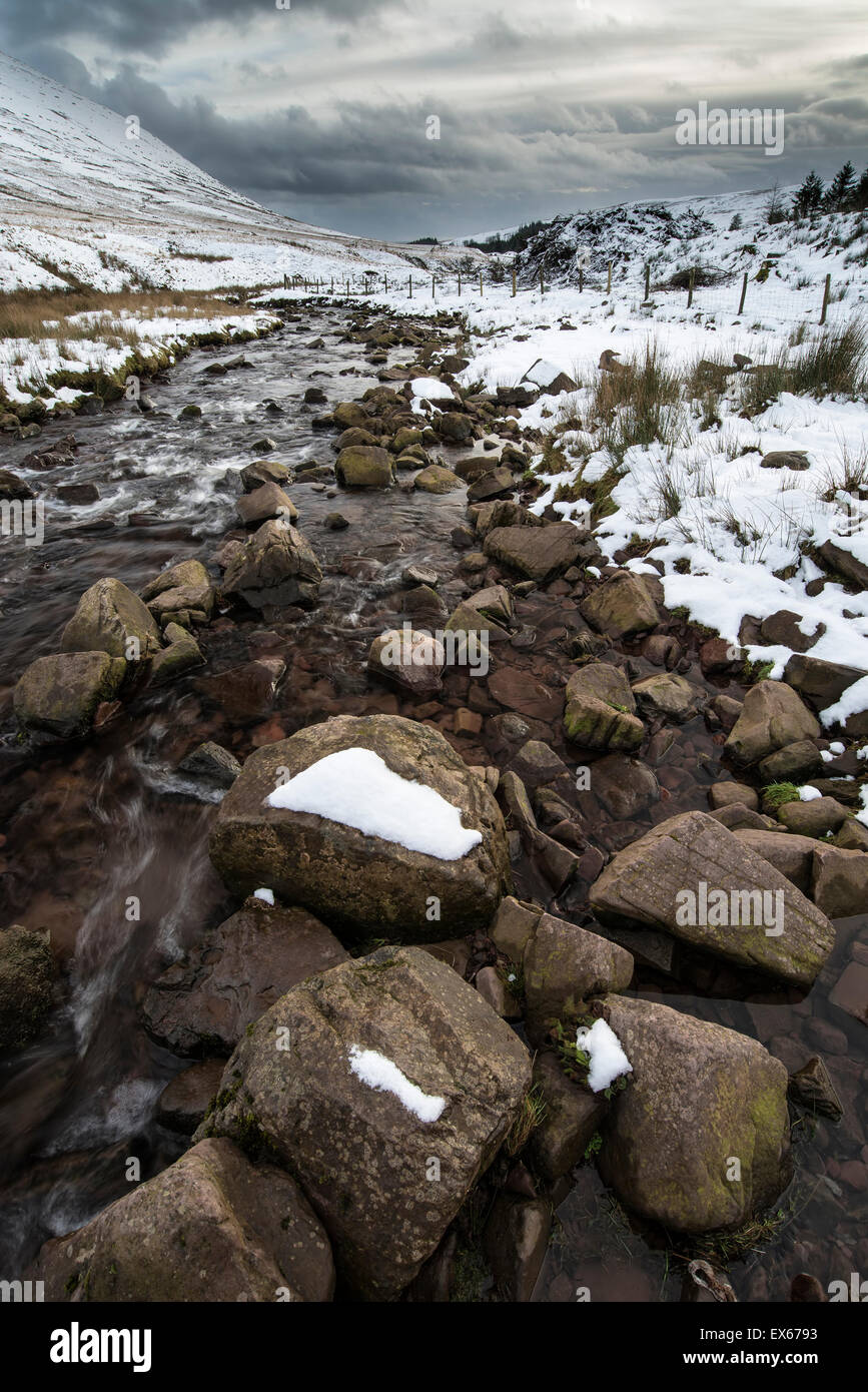 Stream flowing through snow covered Winter landscape in mountains Stock ...