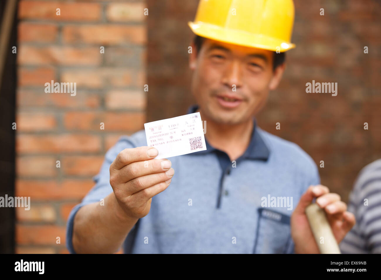 Construction worker with train ticket Stock Photo - Alamy