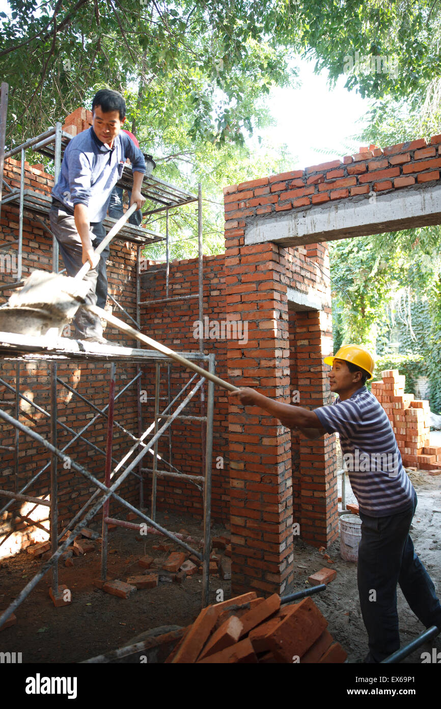 Bricklayers at construction site Stock Photo - Alamy