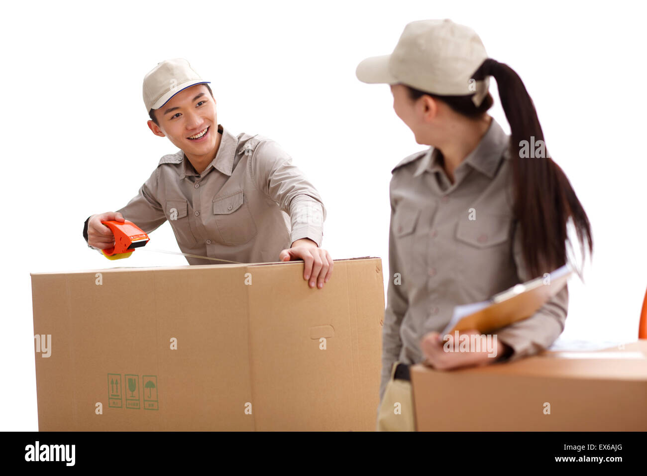 Young man packing cardboard boxes Stock Photo - Alamy