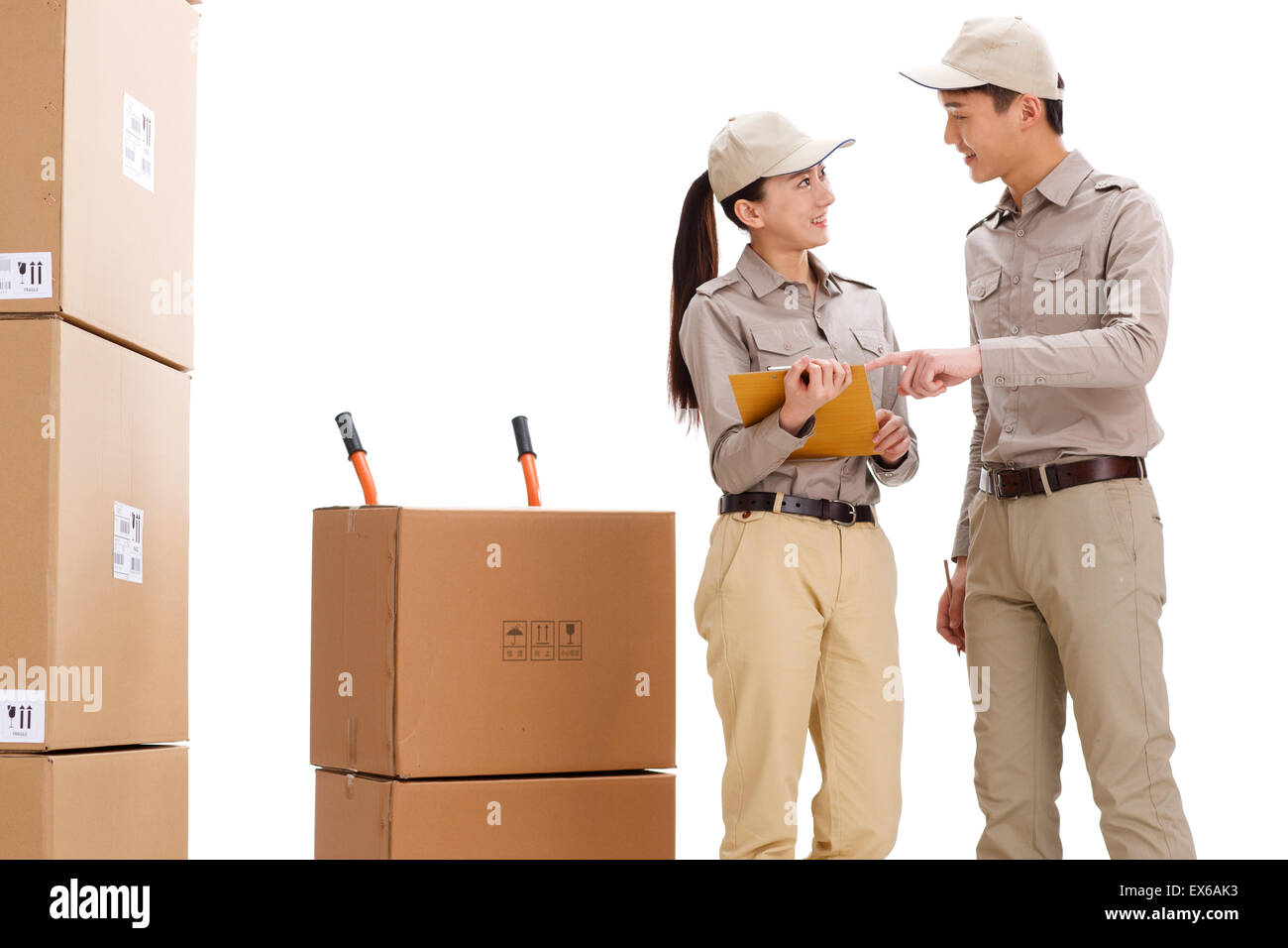 Young man and young woman working in warehouse Stock Photo - Alamy