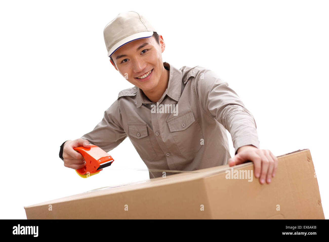 Young man packing cardboard boxes Stock Photo - Alamy