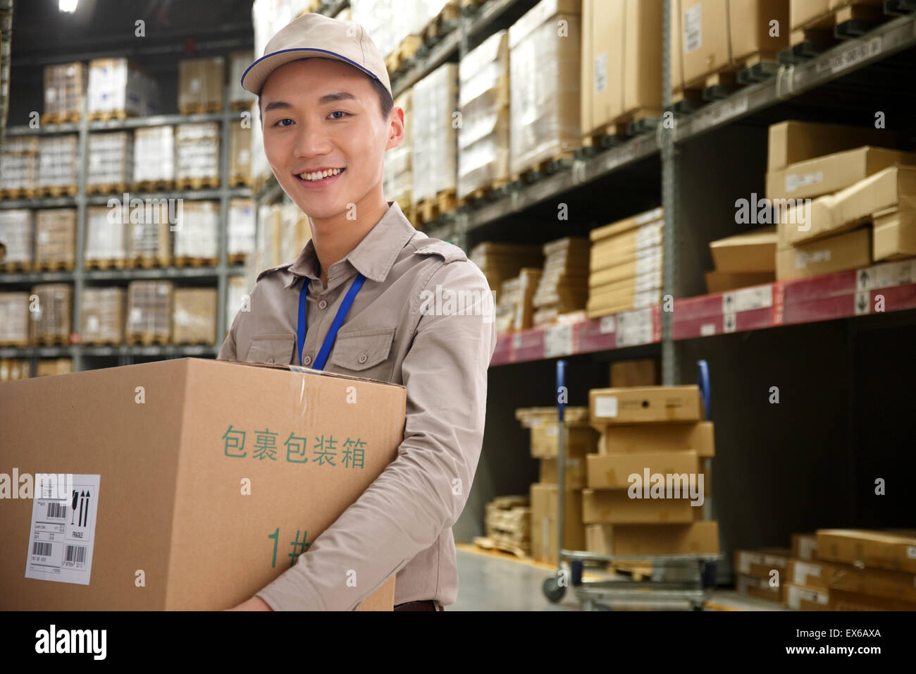 Young man working in warehouse Stock Photo - Alamy