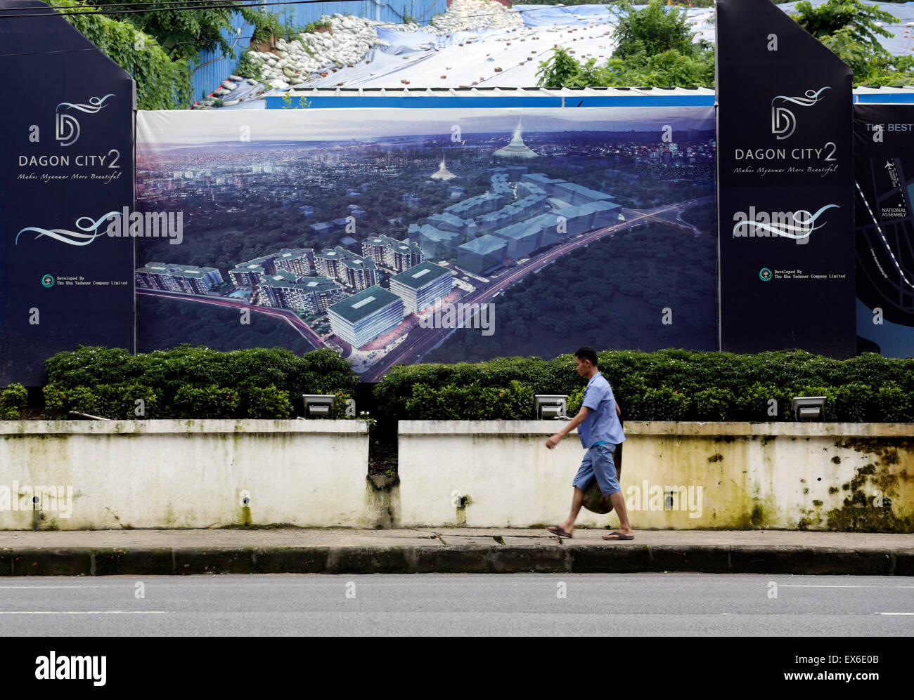 Yangon, Myanmar. 8th July, 2015. A man walks past the construction site ...