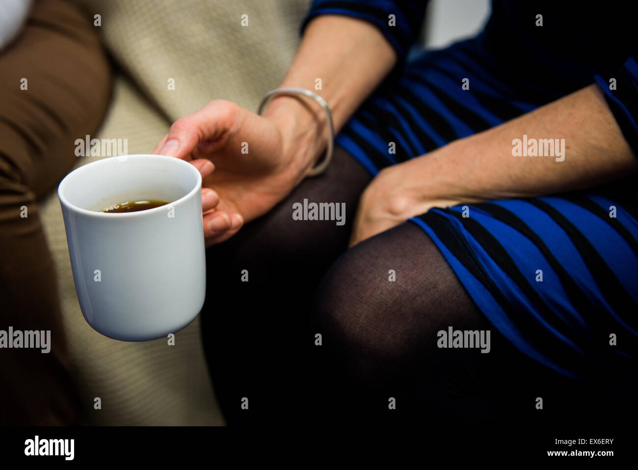 Girl drinking cup of tea and talking Stock Photo - Alamy