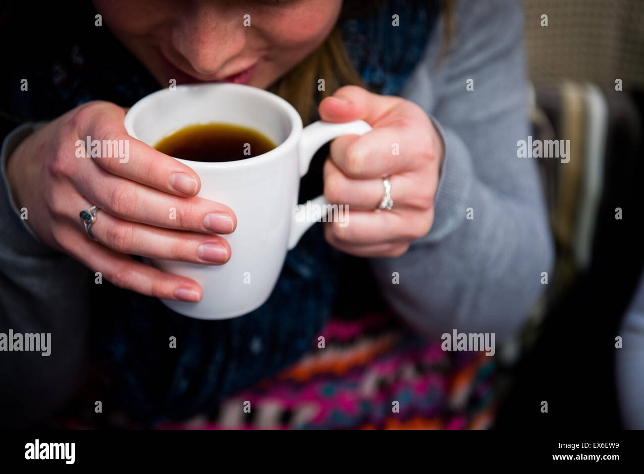 Girl drinking cup of tea and talking Stock Photo - Alamy