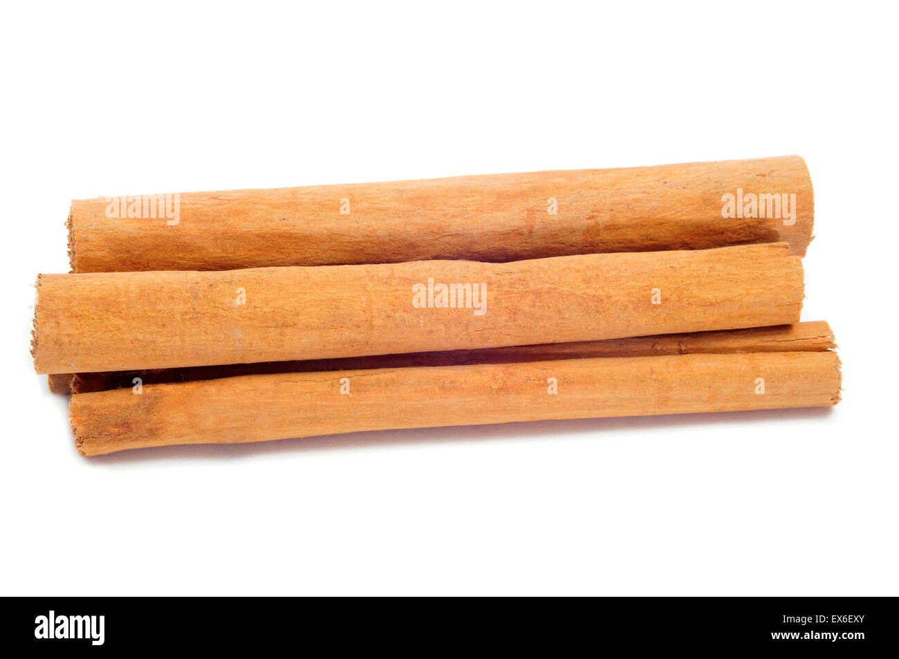 some cinnamon quills on a white background Stock Photo - Alamy