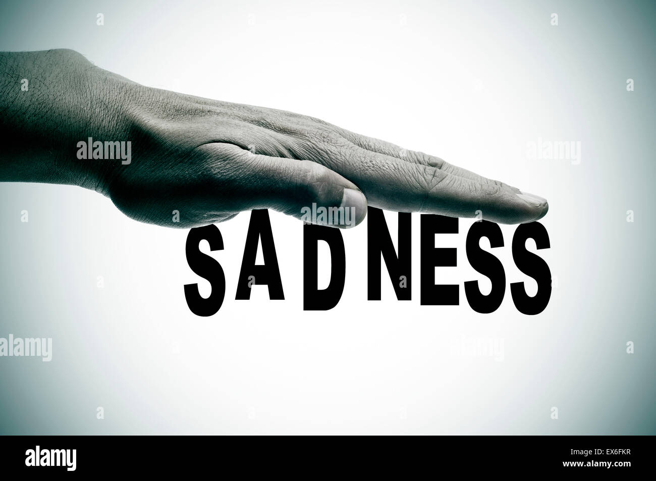 a man hand and the sentence sadness written in black Stock Photo - Alamy