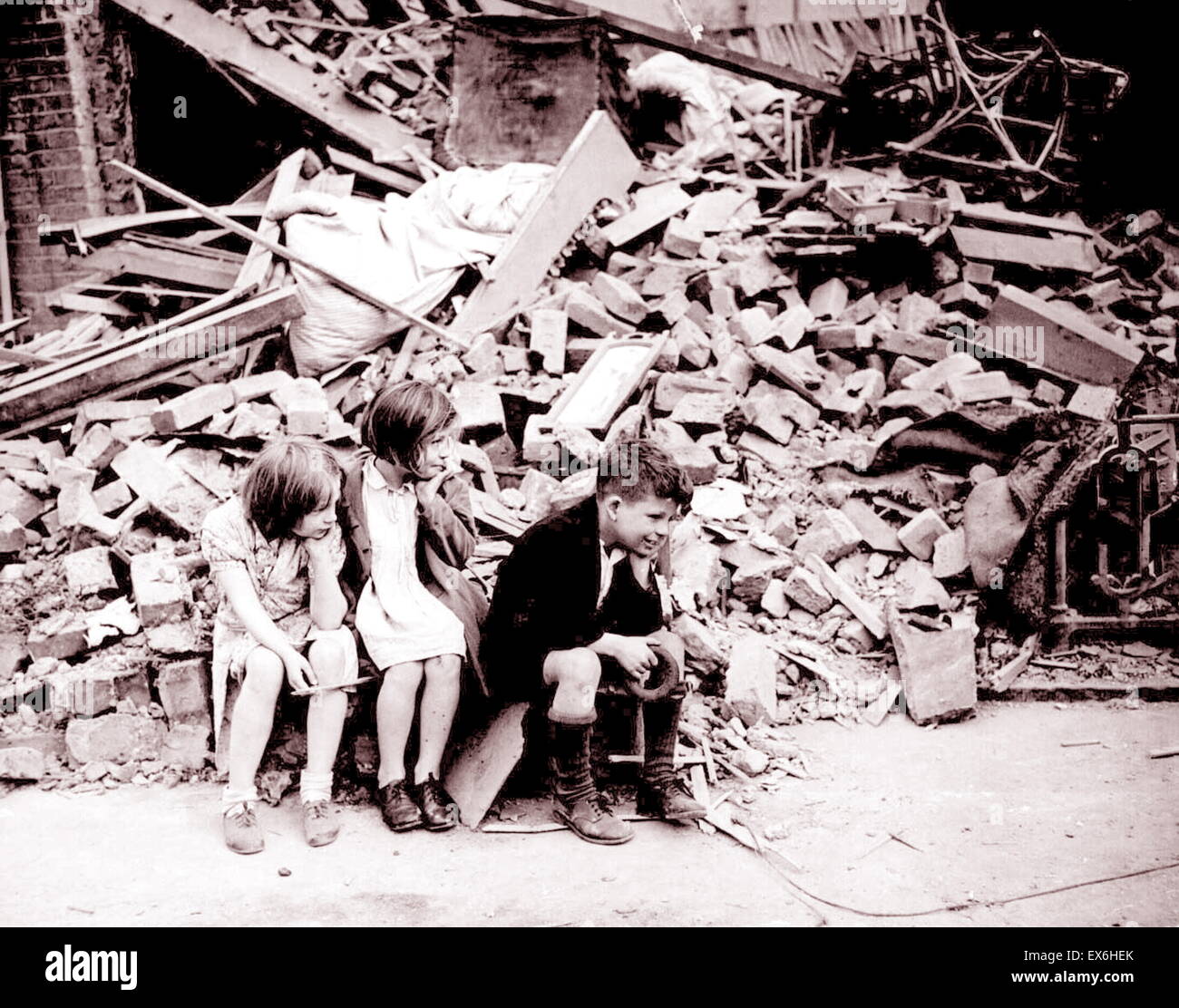 Homeless children sit in front of their wrecked home, in London's East ...