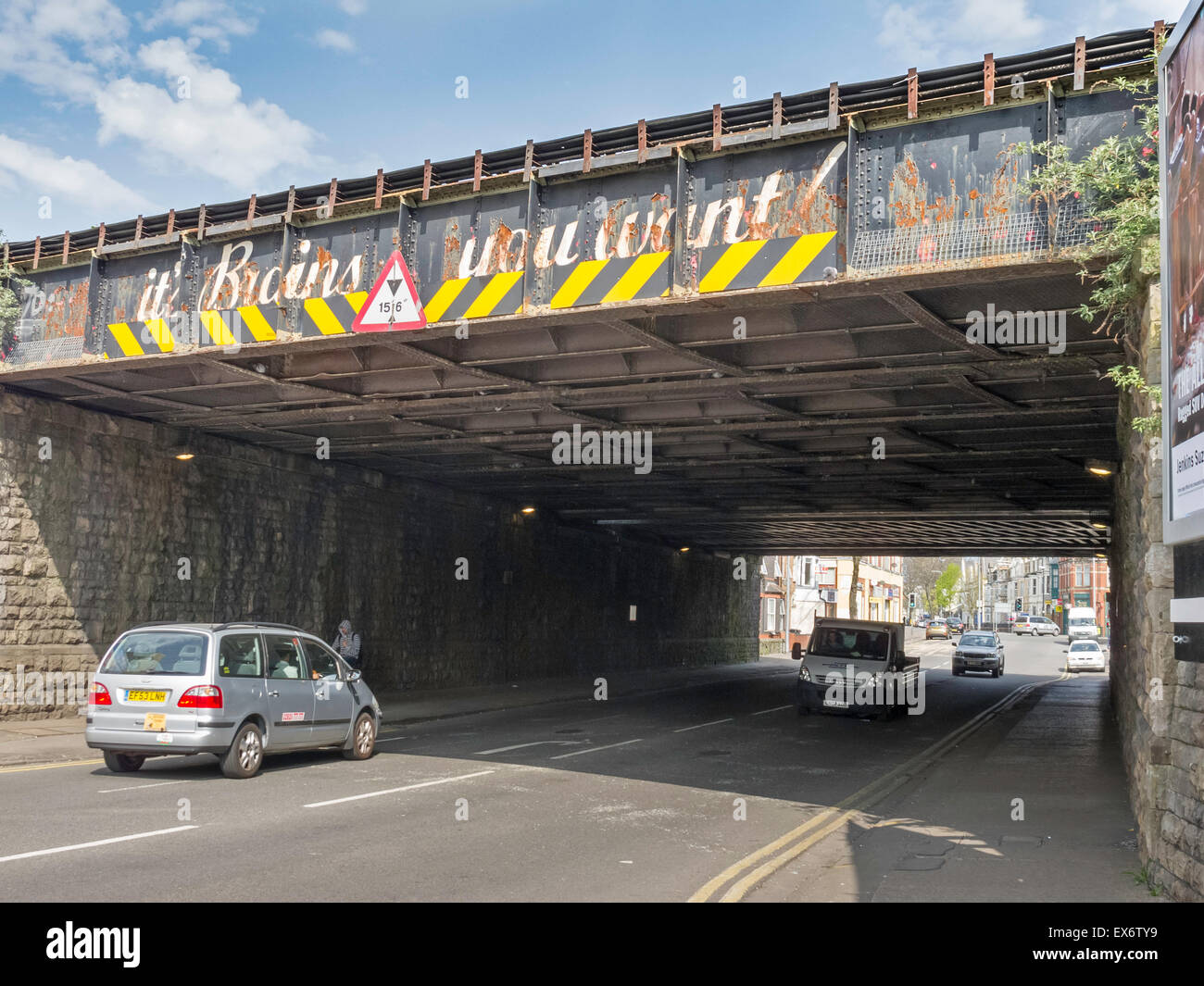 Railway bridge painted with a Brains beer slogan in Cardiff, Wales ...