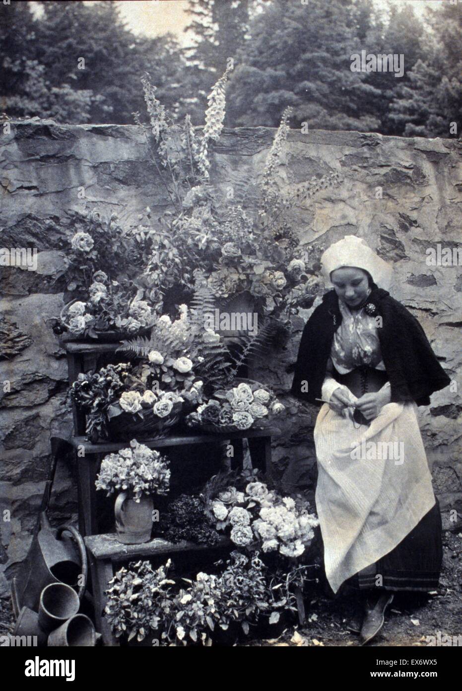 Dutch flower seller, woman dressed in Dutch-style costume standing and ...
