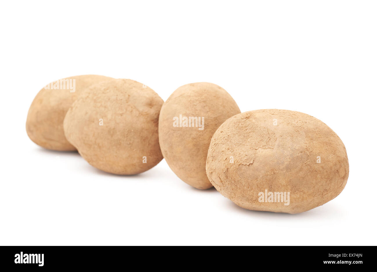 Four brown potatoes lined up Stock Photo - Alamy