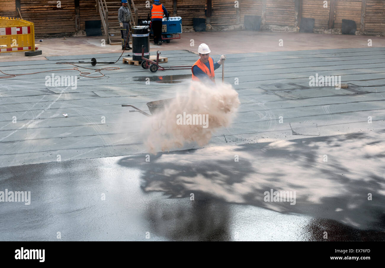 Construction worker applying chalk to an asphalt surface. Dusseldorf ...
