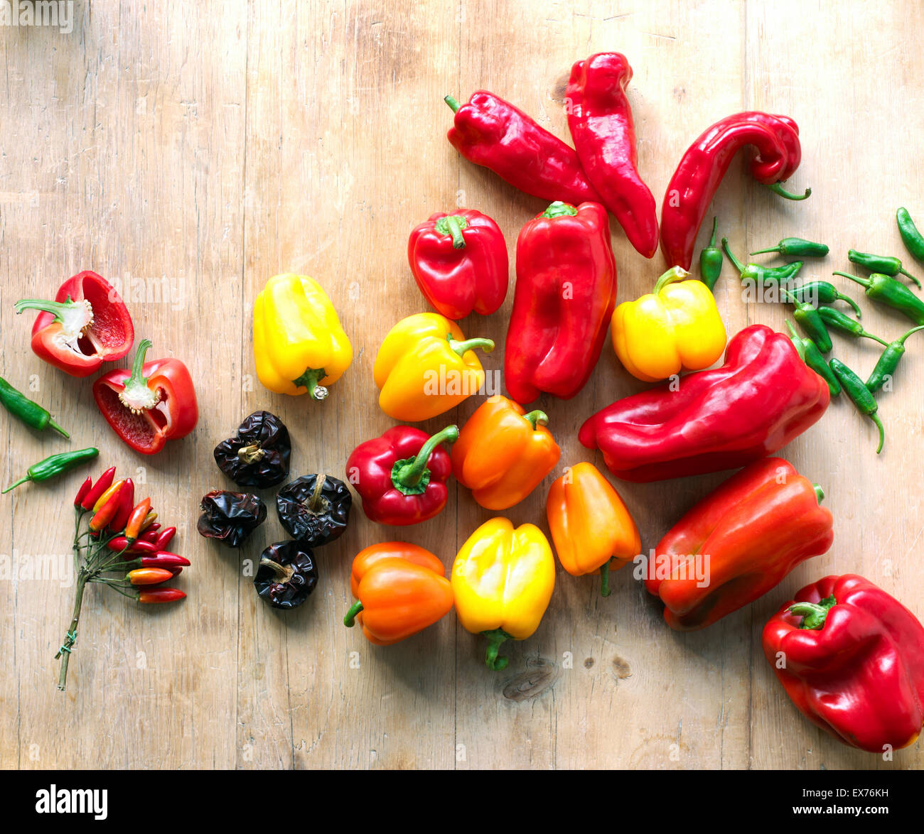 Peppers on wood background Stock Photo - Alamy