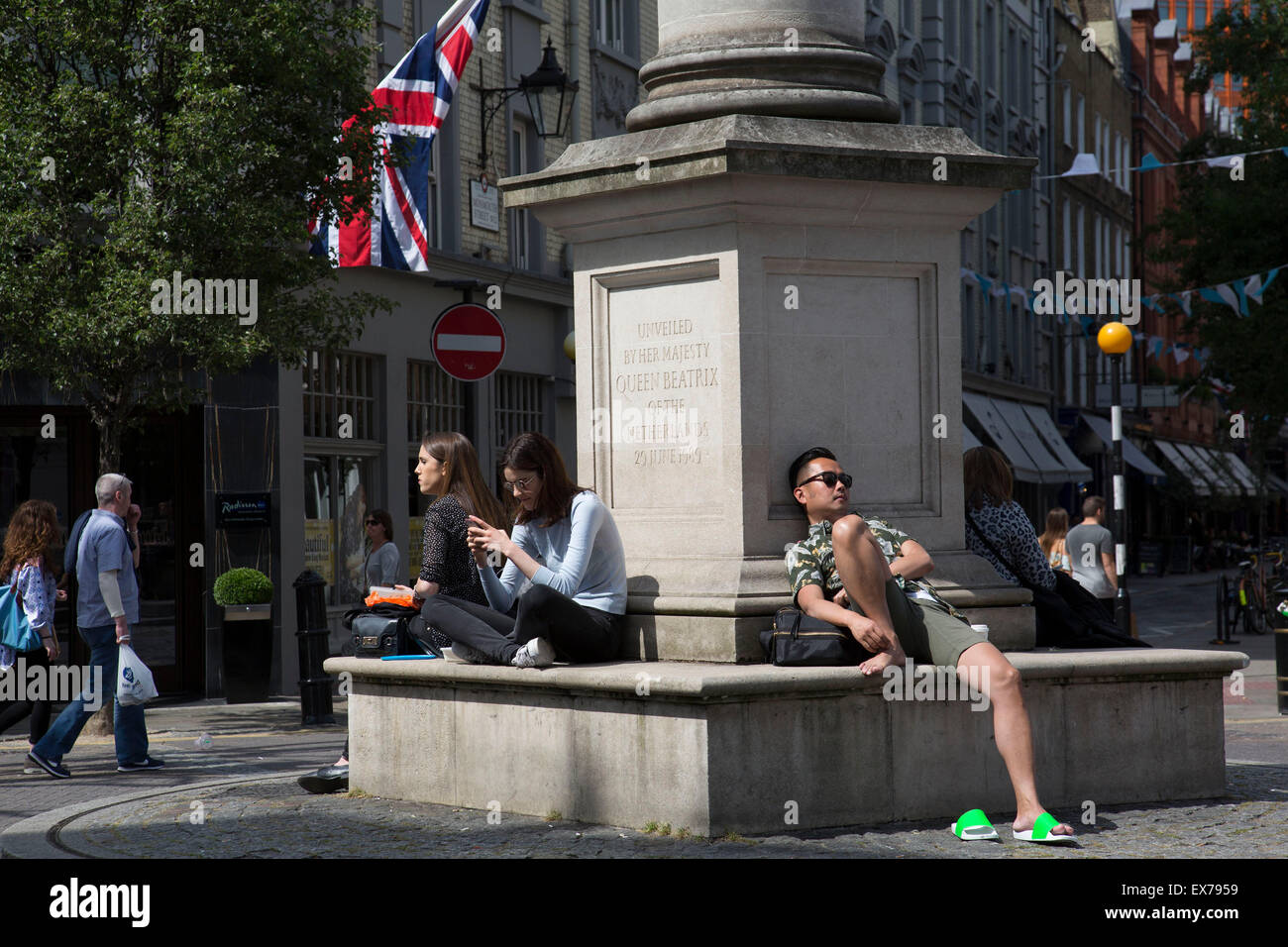 Summertime in London, England, UK. Relaxing in the sun at Seven Dials ...