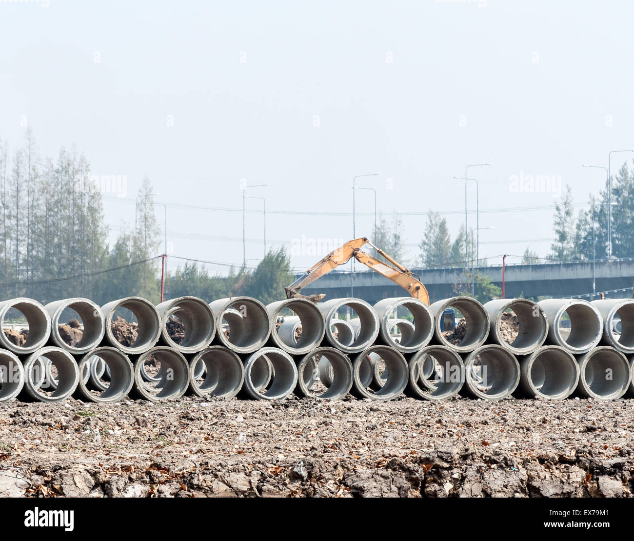 Concrete pipe piles on the ground of construction site Stock Photo - Alamy