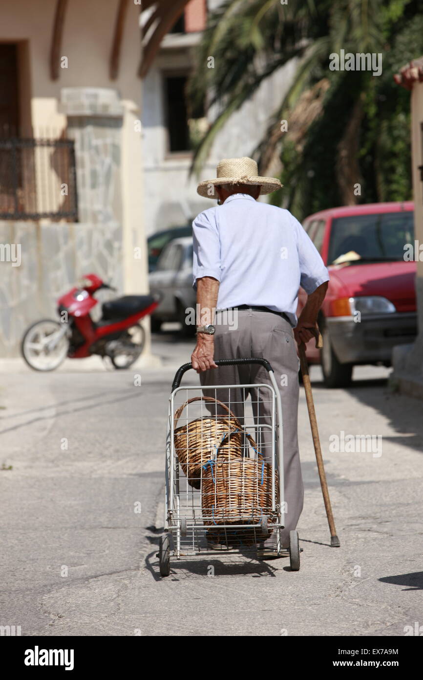 Man carrying his dried figs production back home with a portable ...