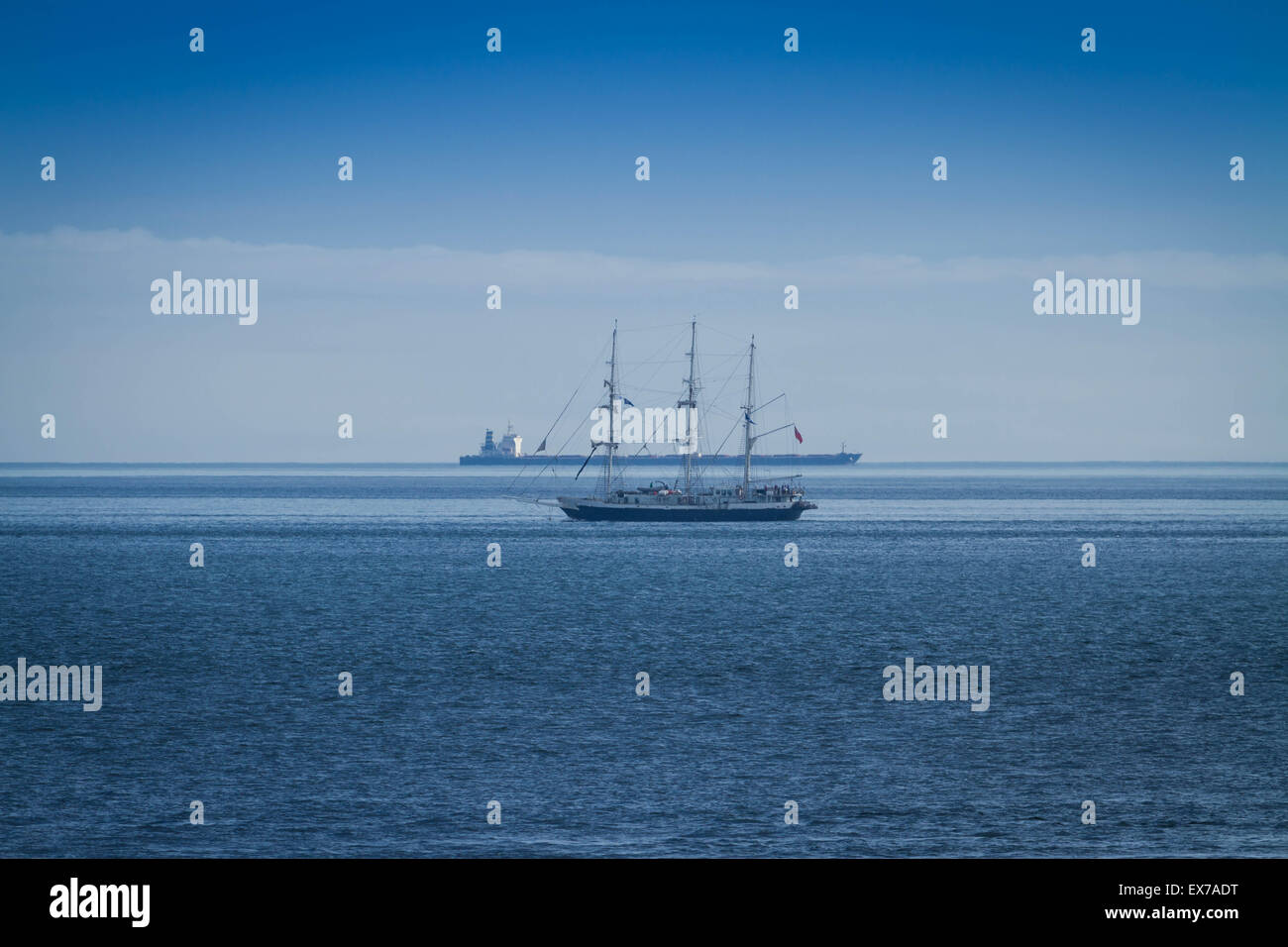 A Tall Ship off the North Antrim Coast N Ireland with a large Tanker in ...