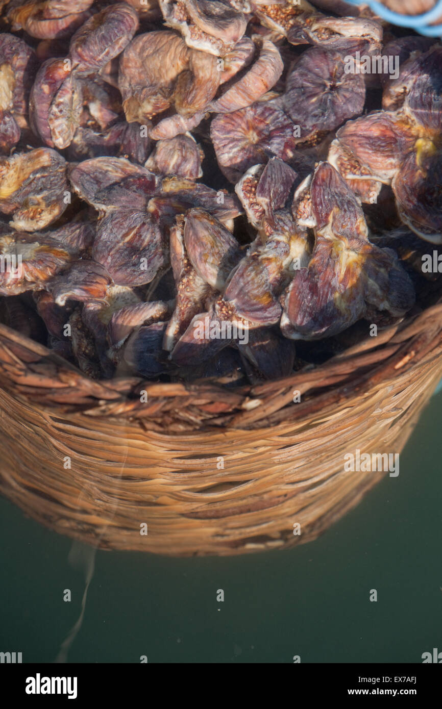 Greek dried figs processing . Basket filled with fresh figs dipped in ...