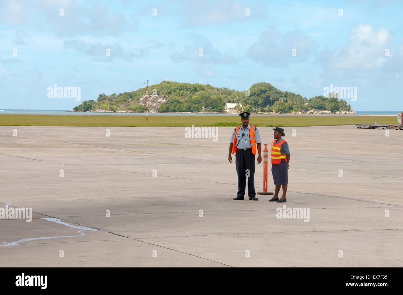 Employees are on the airport runway on the Mahe island, Indian Ocean ...