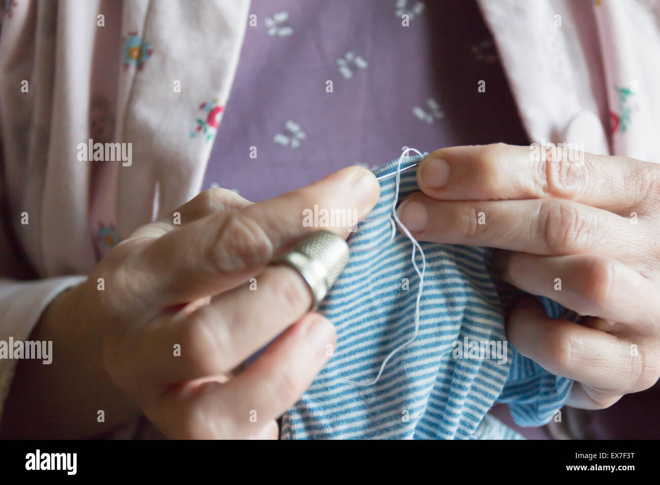 Person Sewing By Hand