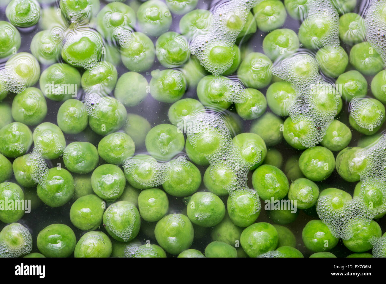 Green peas being boiled in a pot Stock Photo - Alamy