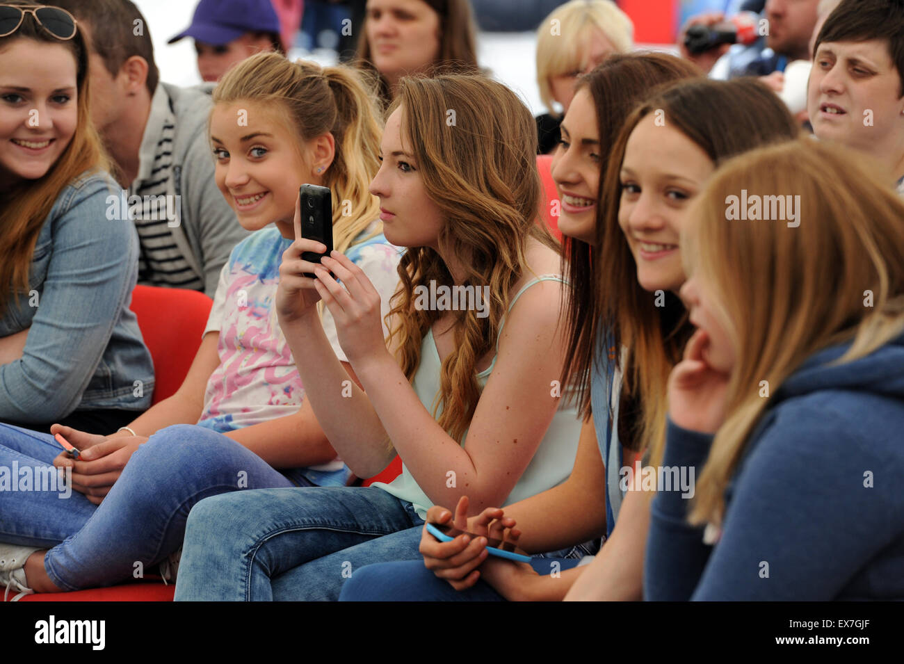 PontyPridd, Wales, UK. Crowd of teenage girls taking photographs with ...