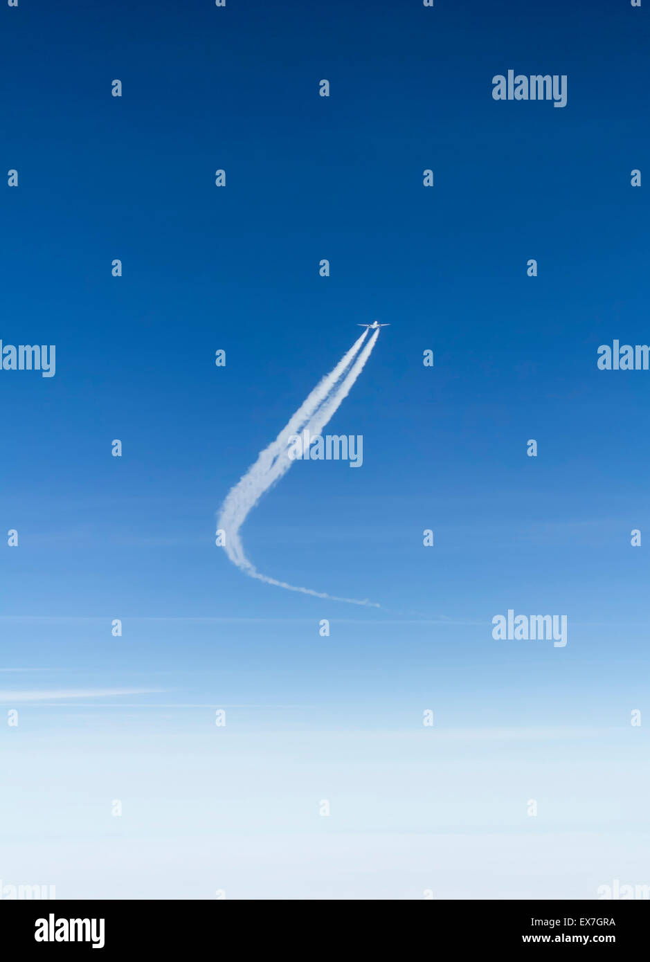 Jet aircraft in flight changing course, vertical format Stock Photo - Alamy