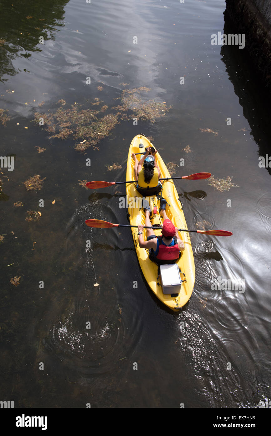 Yellow kayak, with two passengers, shot from above Stock Photo - Alamy