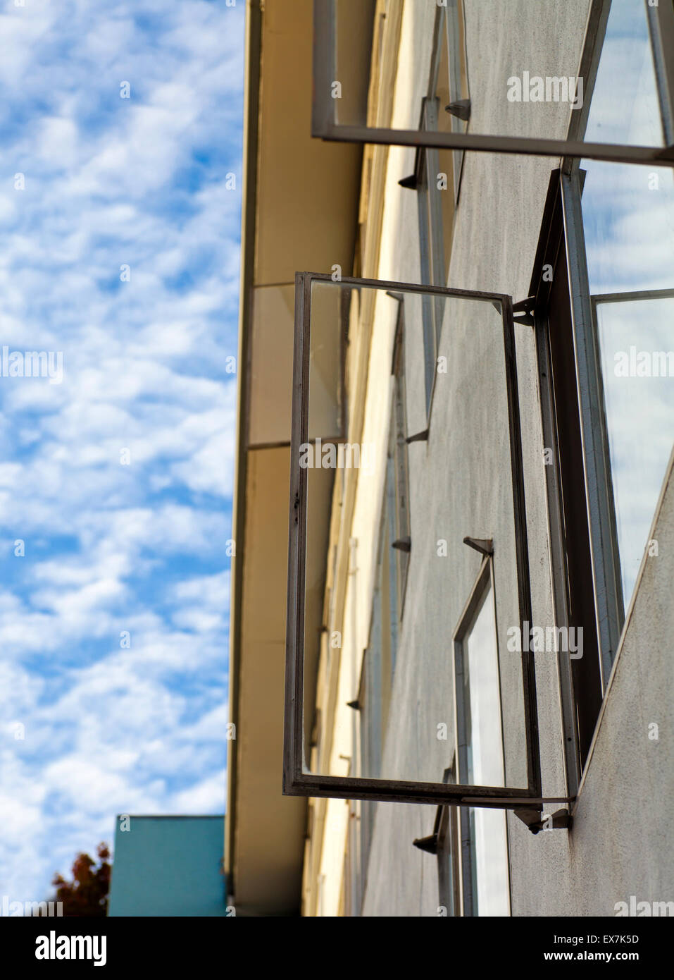 Apartment building wall with windows open, summer day with sunshine ...